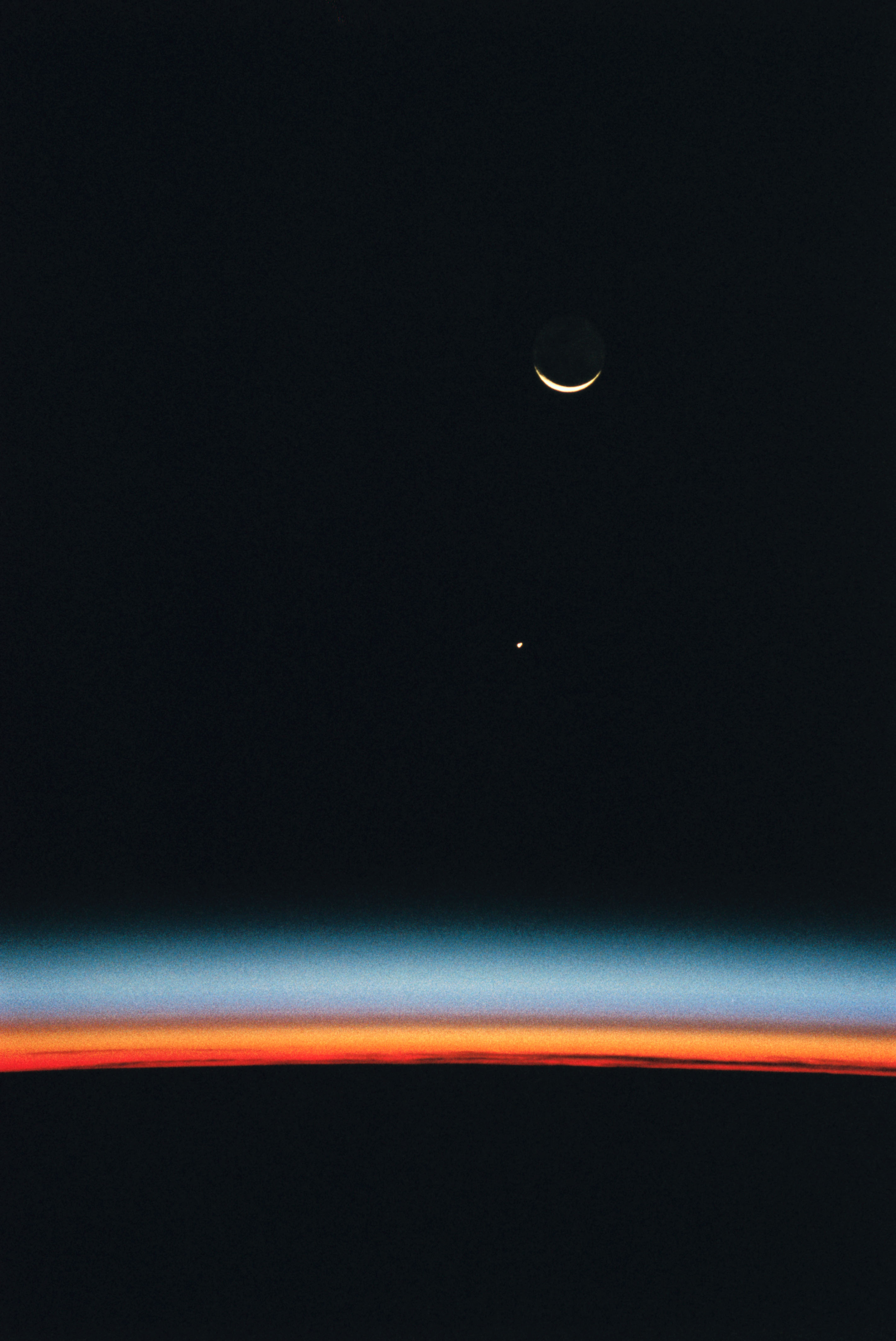 Jupiter rising above the airglow over Earth's horizon with the crescent ...